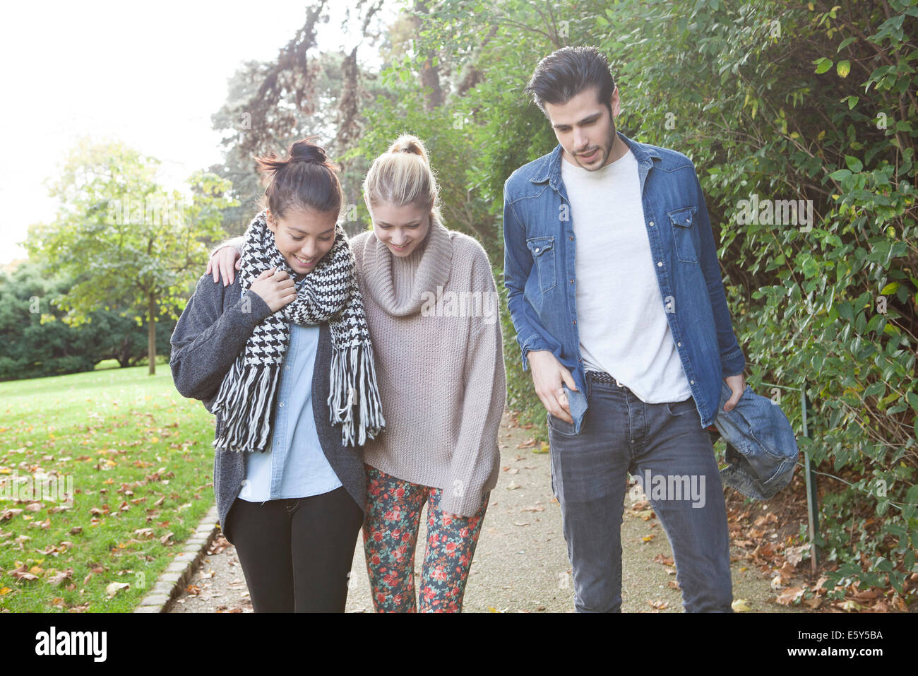 Friends strolling together in park Stock Photo - Alamy