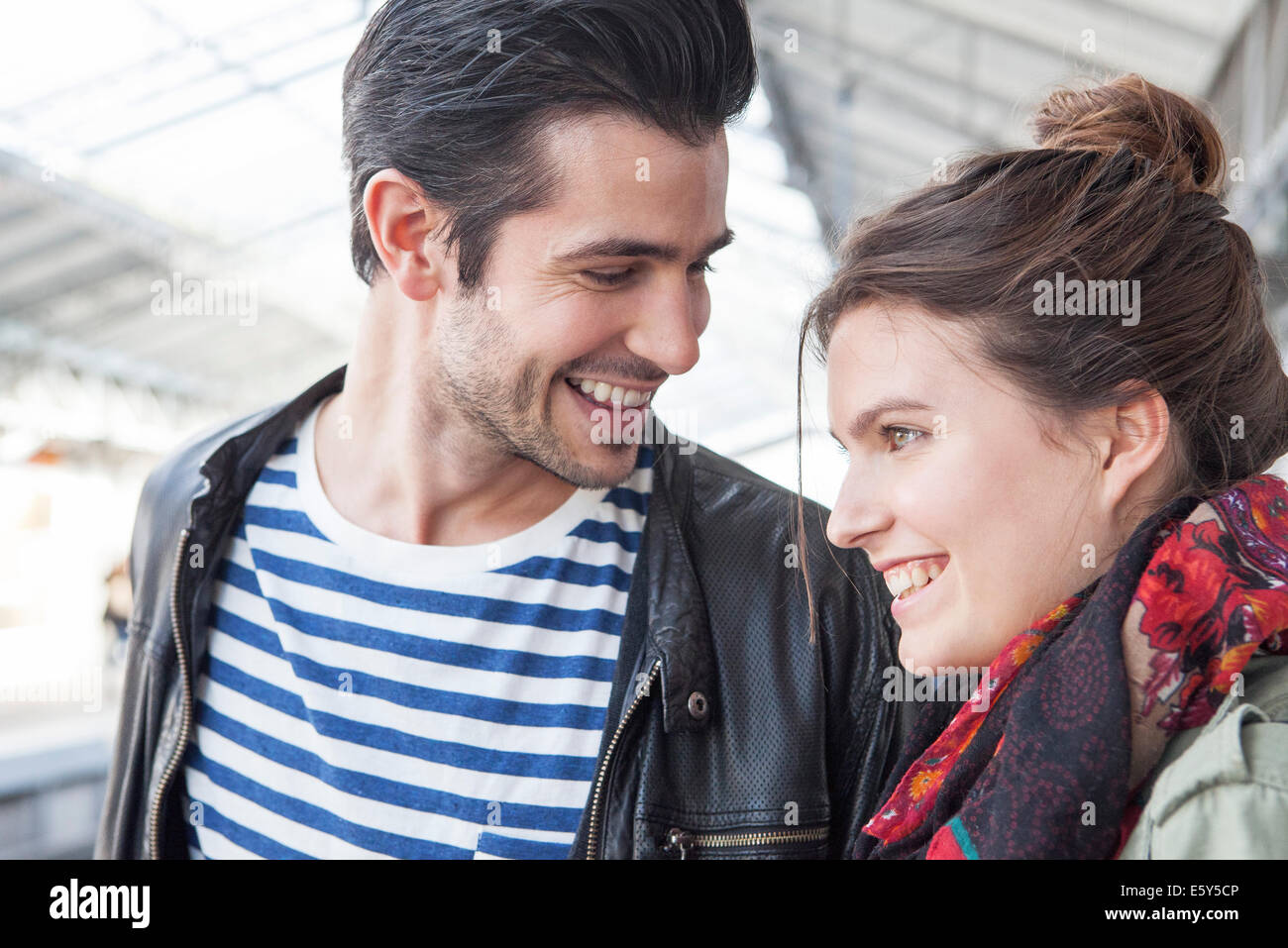 Young couple together on train platform Stock Photo - Alamy