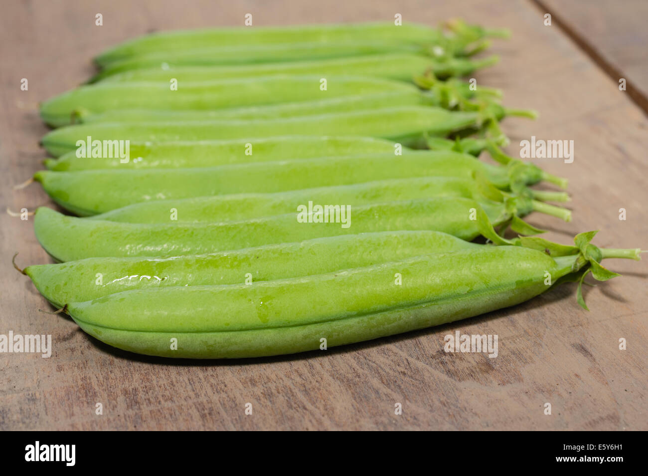 Group of fresh green pea pods on a table Stock Photo - Alamy