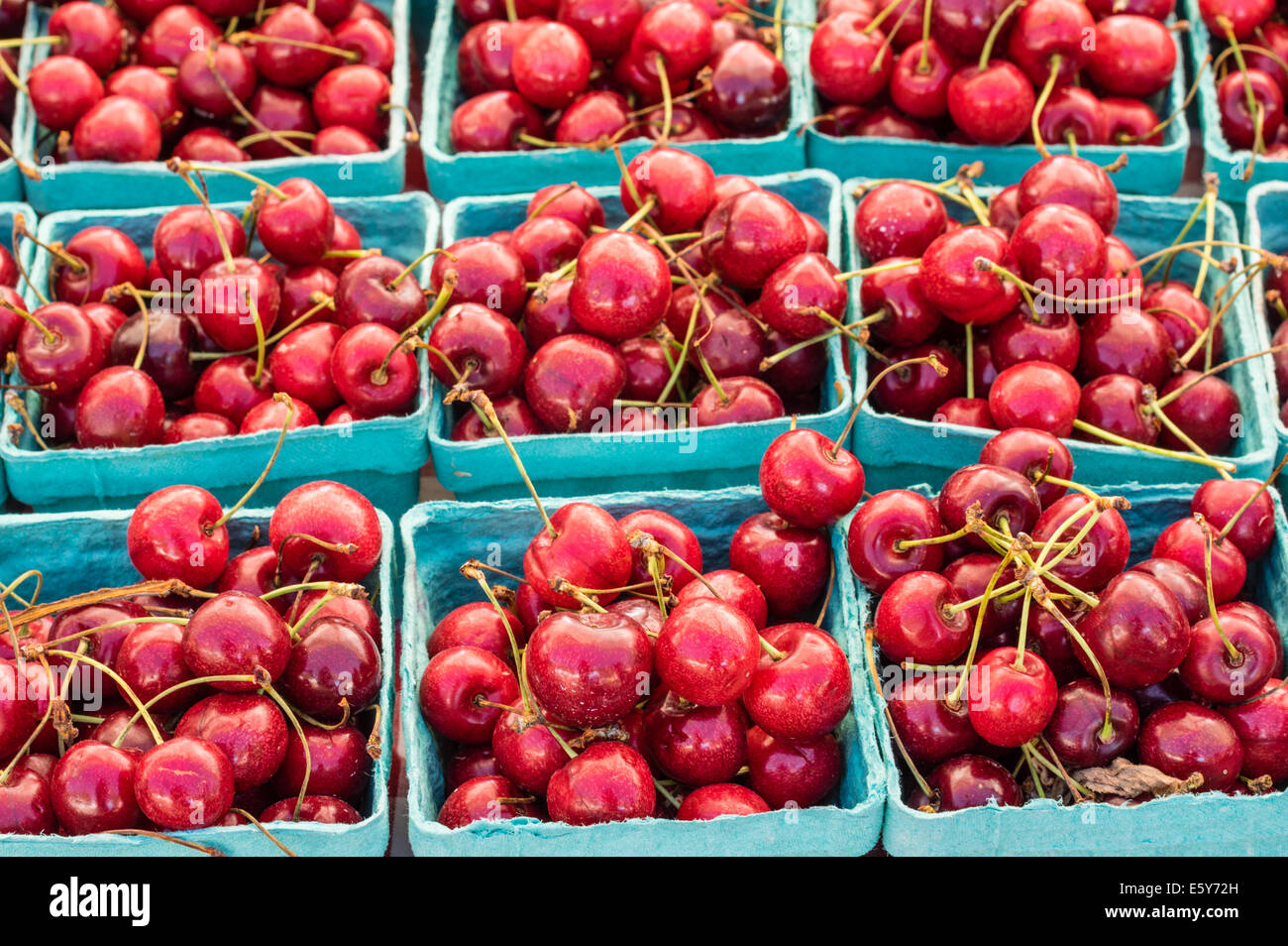 Freshly picked sweet red cherries in boxes at the market Stock Photo ...