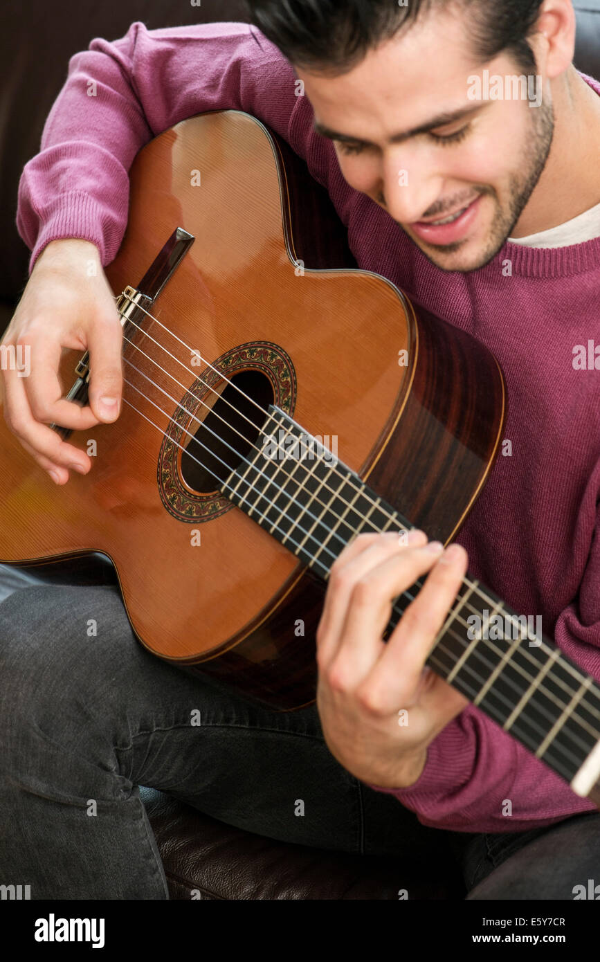 Young man playing acoustic guitar Stock Photo - Alamy