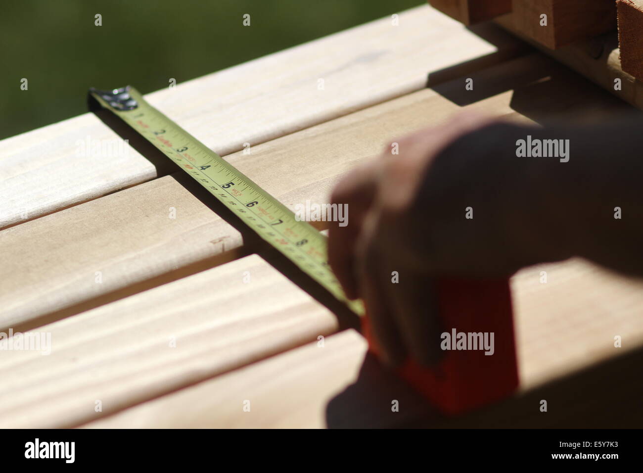 A man working measuring wood Stock Photo - Alamy