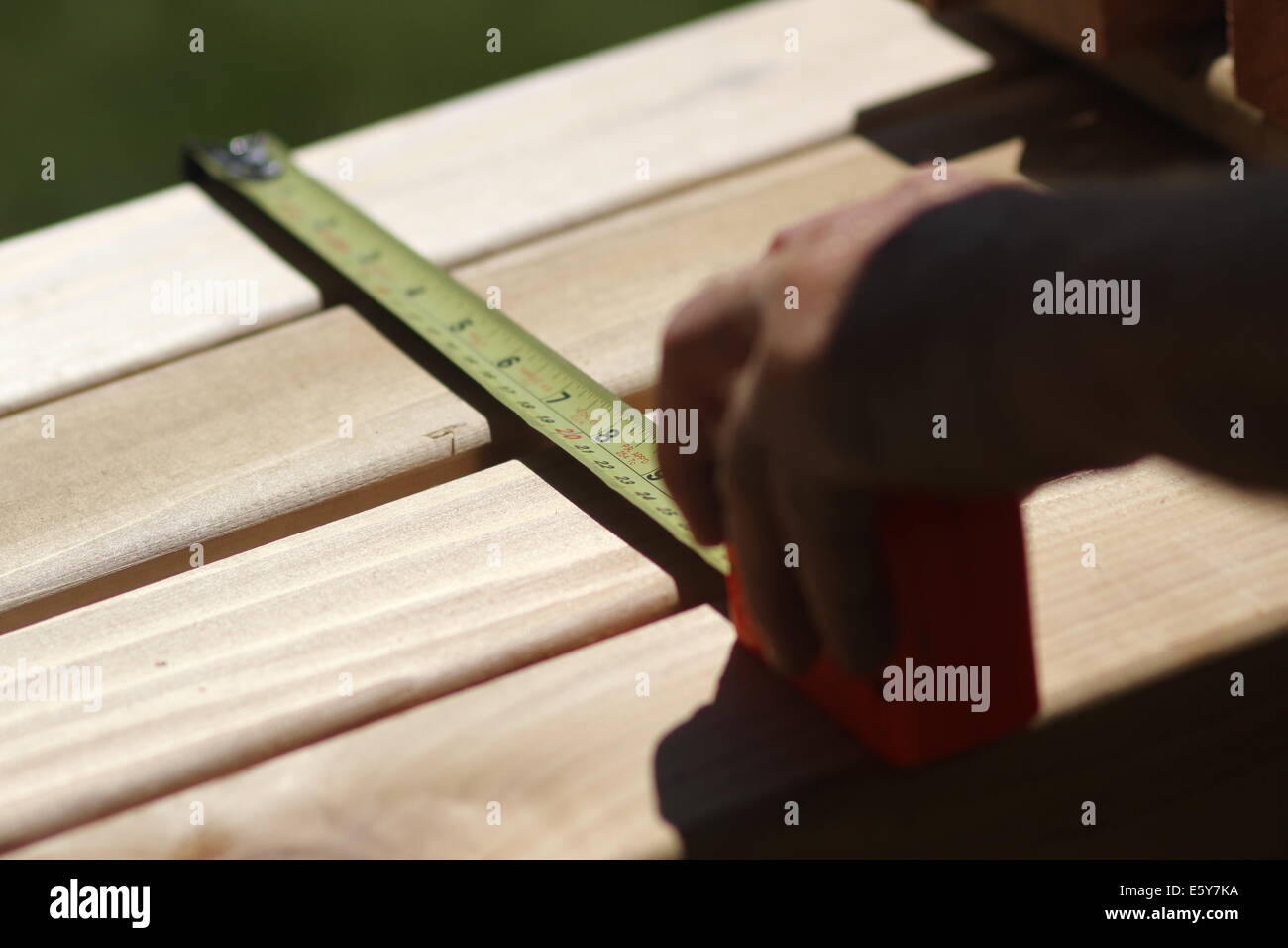 A man working measuring wood Stock Photo - Alamy