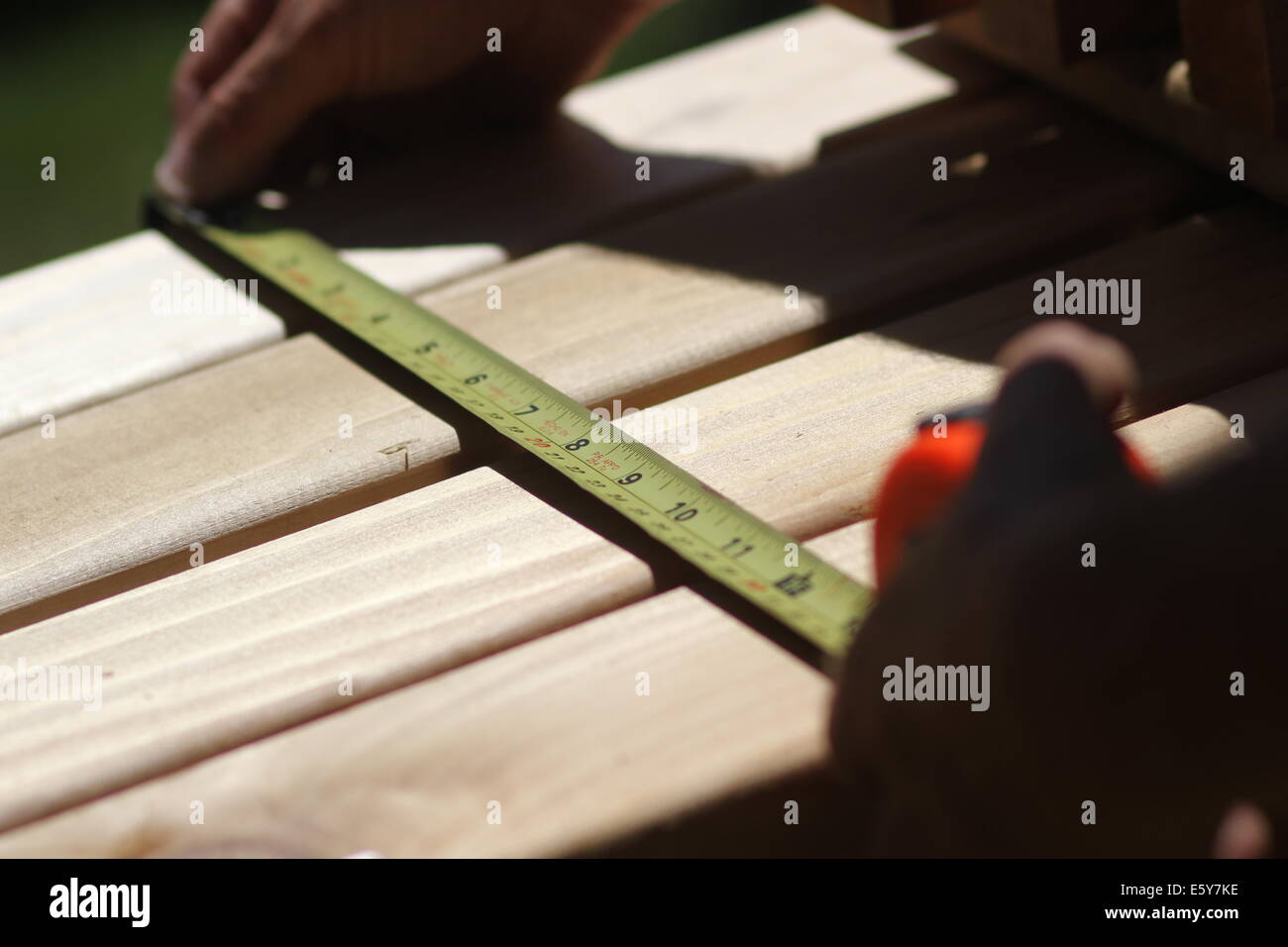 A man working measuring wood Stock Photo - Alamy