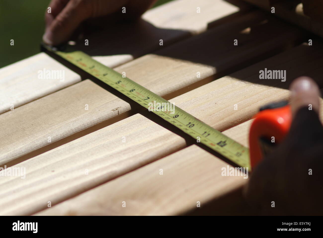 A man working measuring wood Stock Photo - Alamy