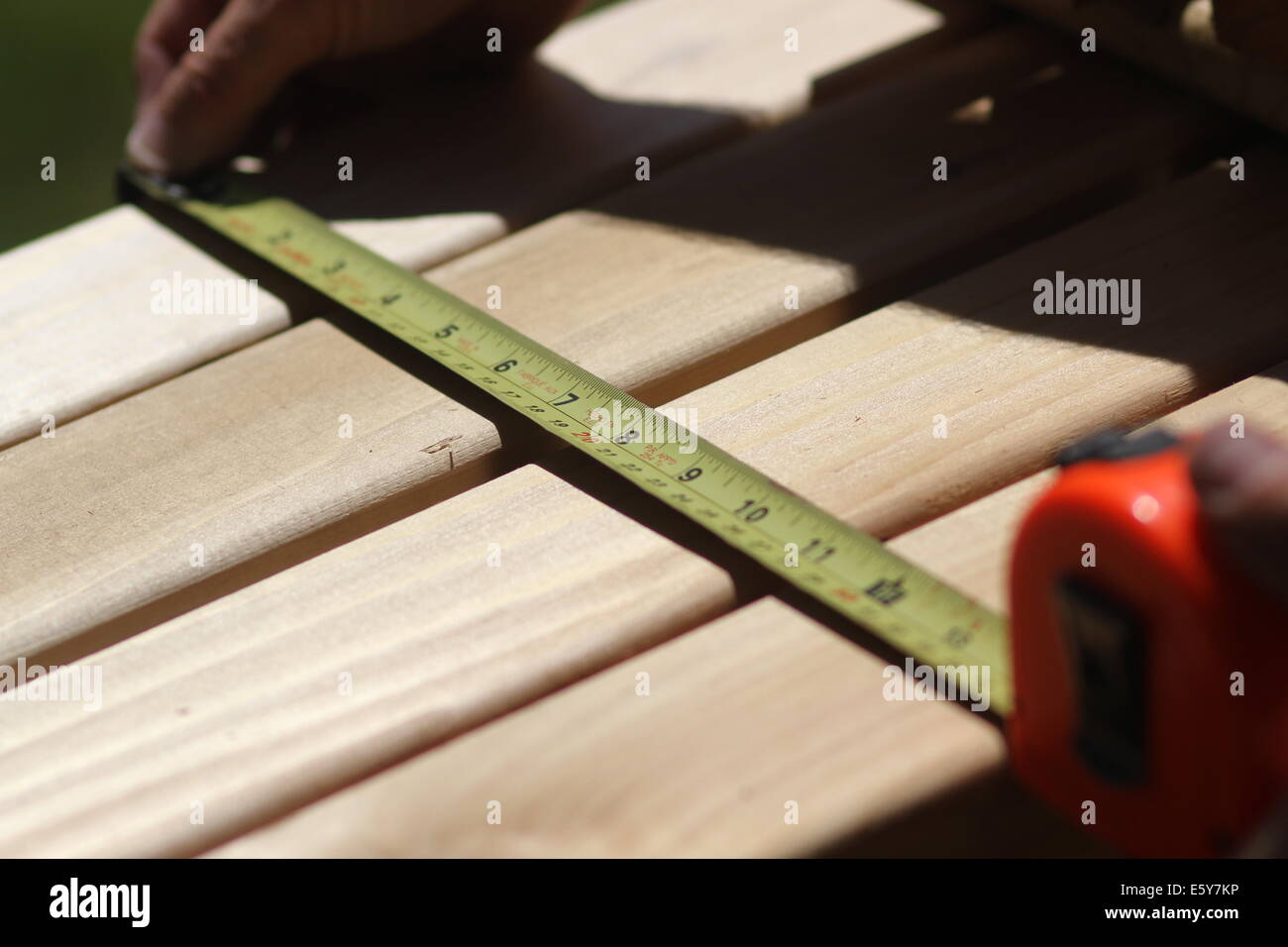A man working measuring wood Stock Photo - Alamy