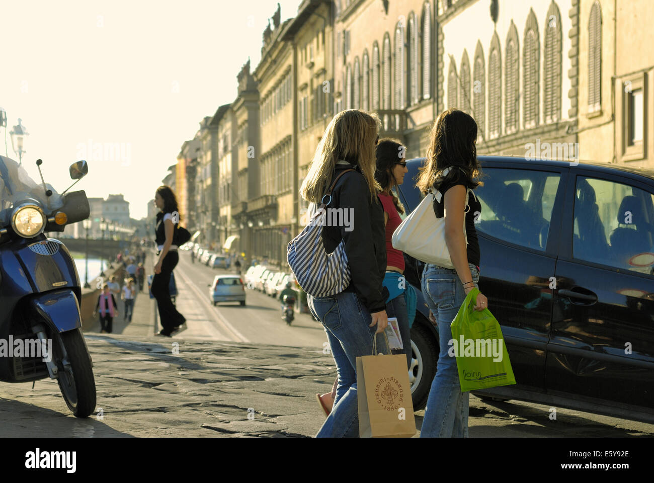 street scene along Ponte Santa Trinita bridge and River Arno, Florence ...