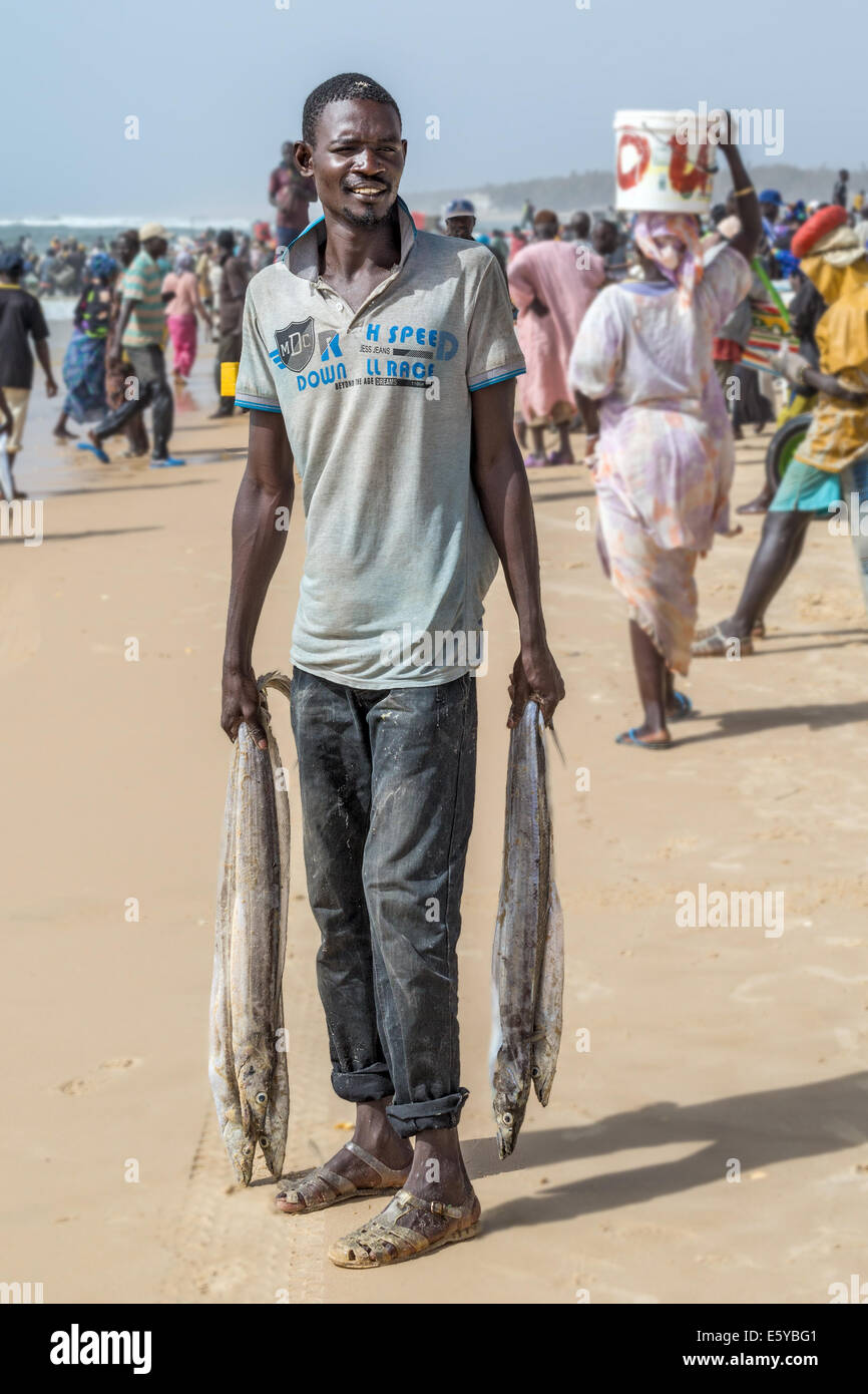 Fisherman wishing to show off his catch, Kayar, Senegal Stock Photo - Alamy