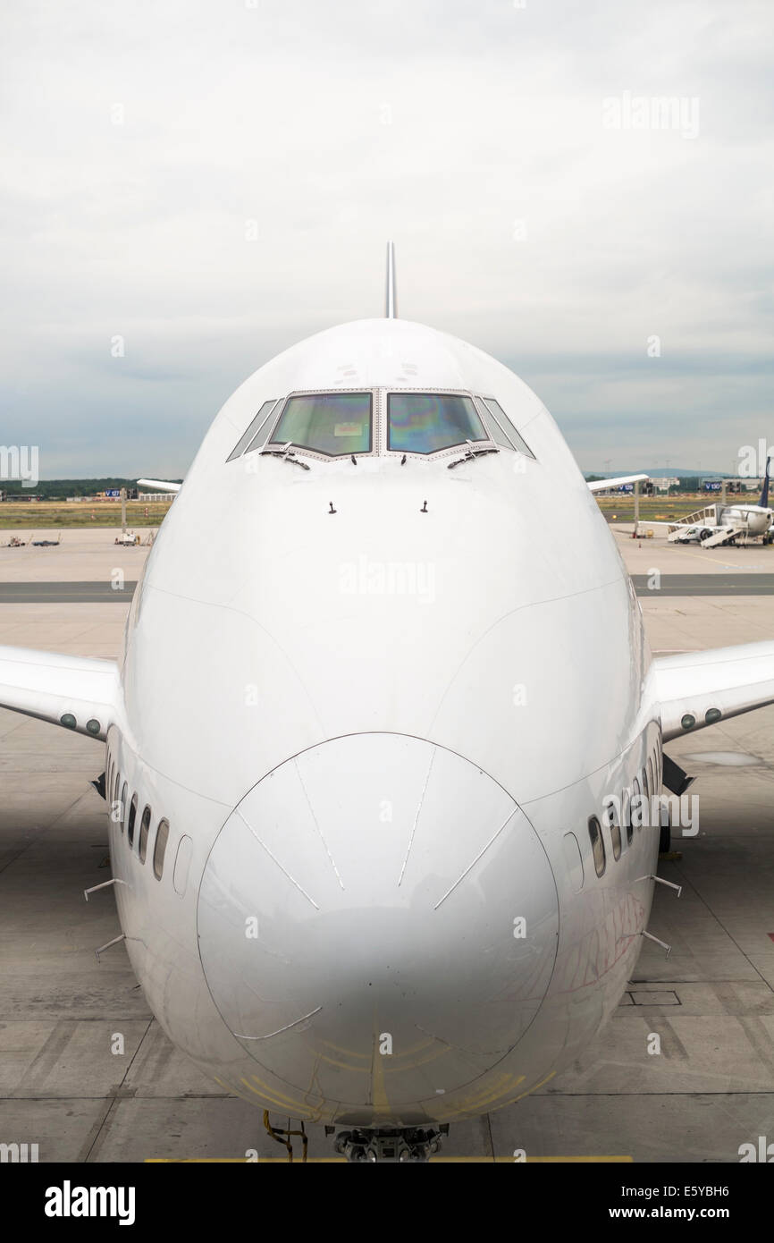 Front of jumbo jet on the ground in perspective Stock Photo - Alamy