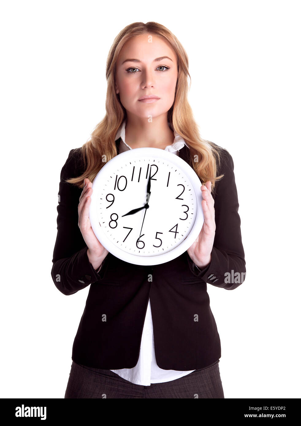 Portrait of serious business woman holding in hands big clock isolated ...