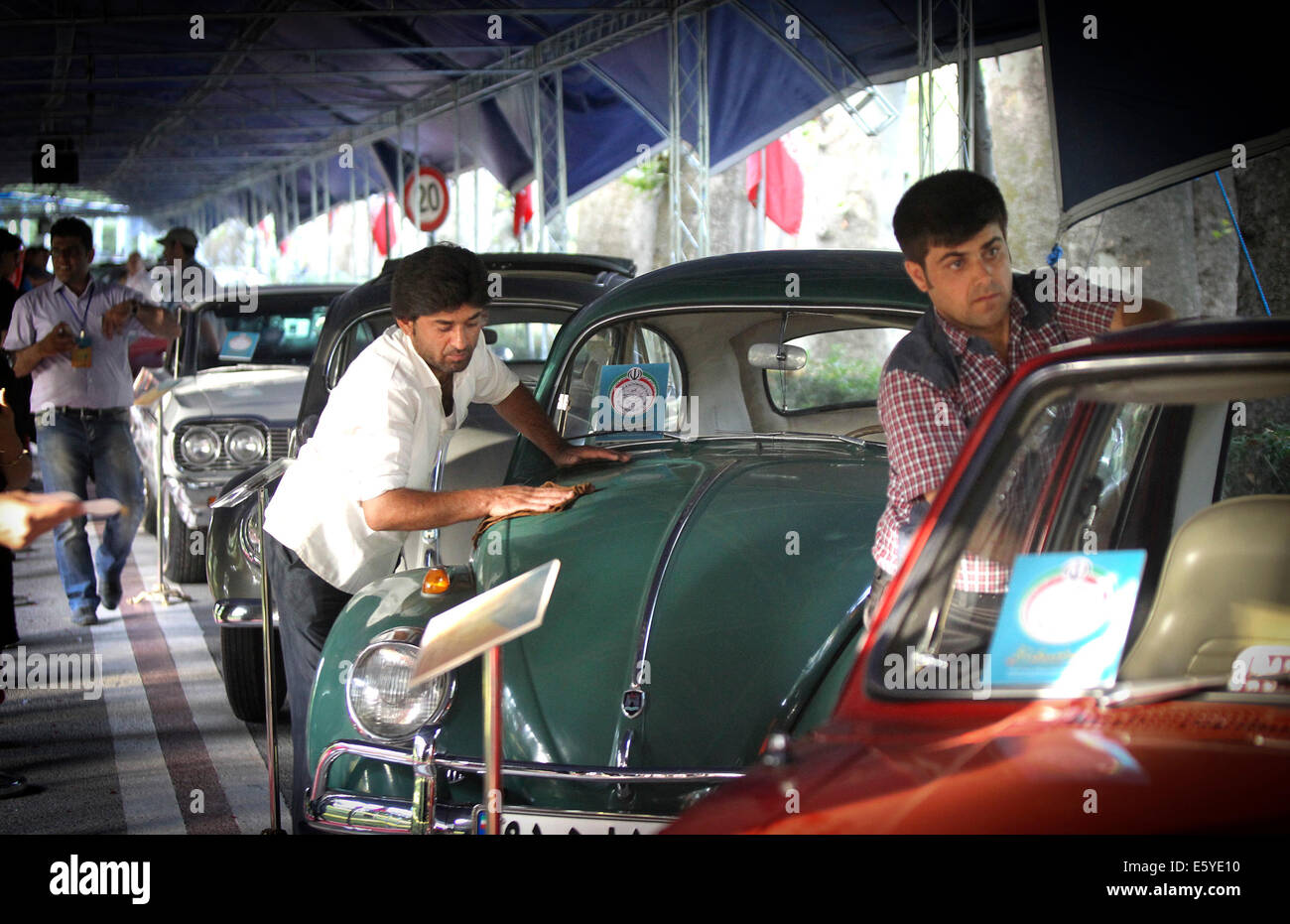 Tehran, Iran. 8th Aug, 2014. Two men clean cars during a classic car ...