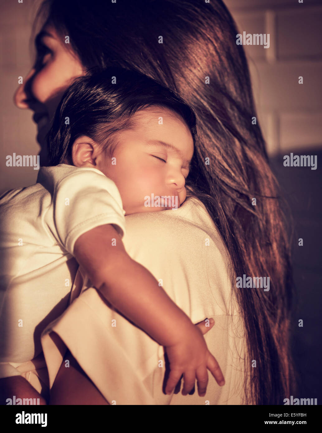 Portrait of mother standing back side and caring little sleeping baby ...