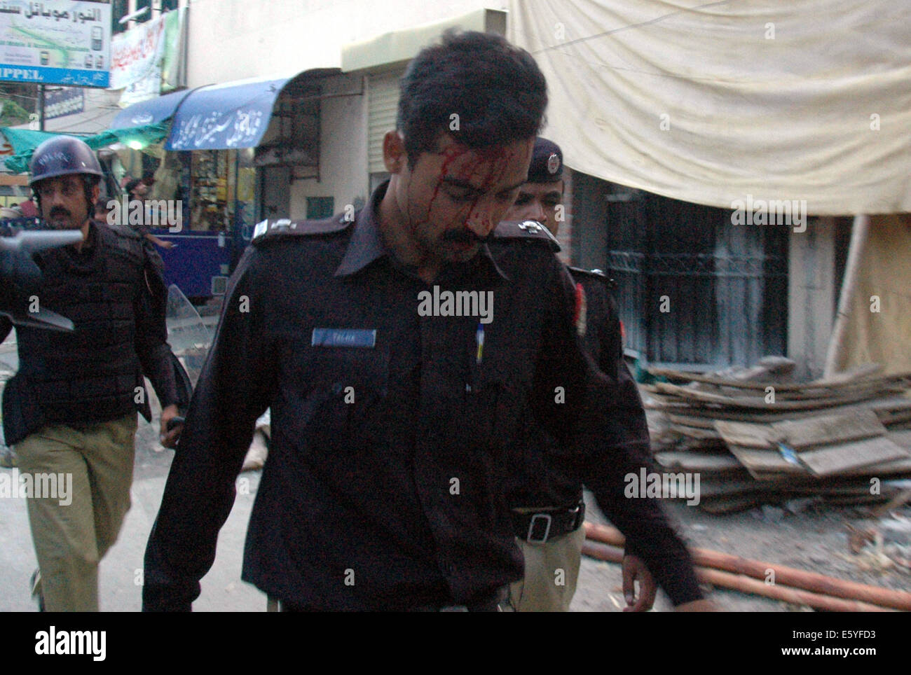 Lahore, Pakistan. 8th Aug, 2014. An injured policeman is seen after a ...