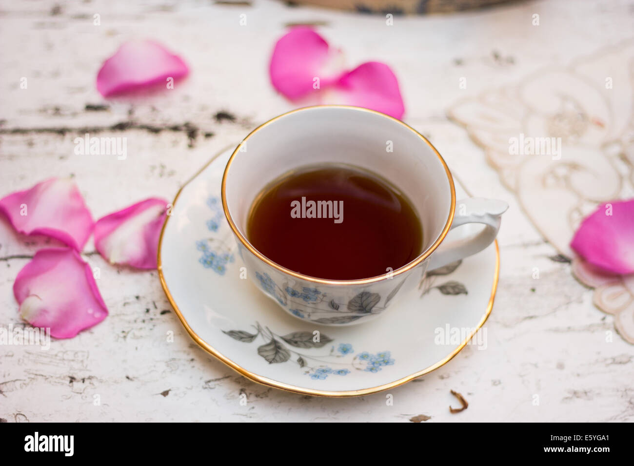 Old fashioned tea set in the garden with petals and flowers Stock Photo ...