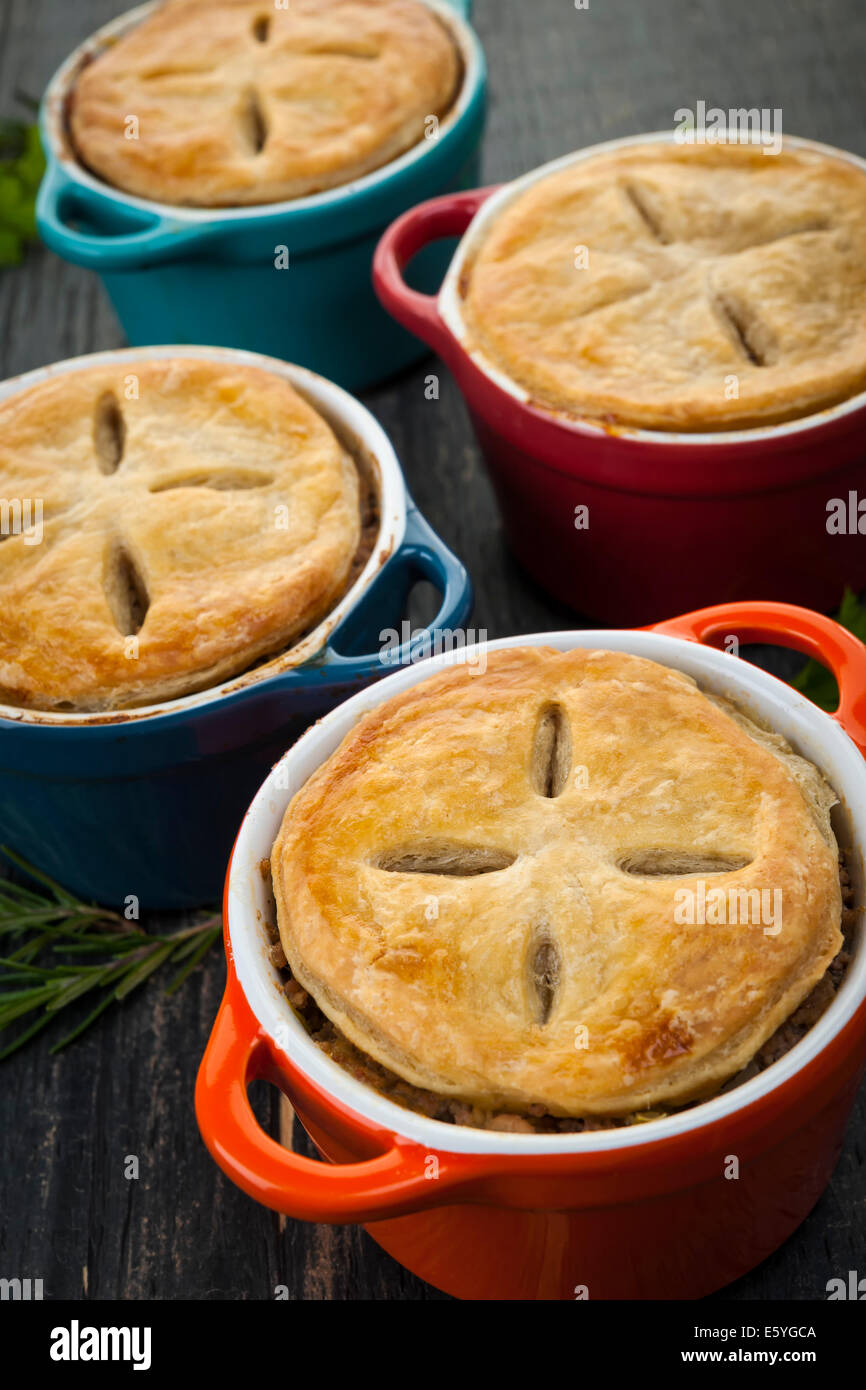 Four homemade gourmet meat pies on wooden background Stock Photo - Alamy