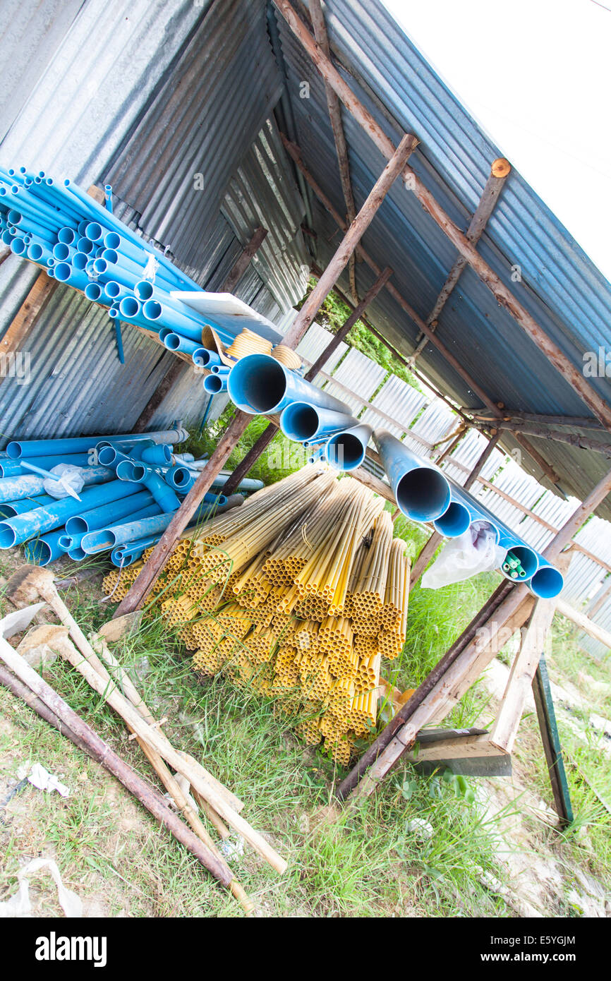 Blue and Yellow Tubes at building site Stock Photo - Alamy