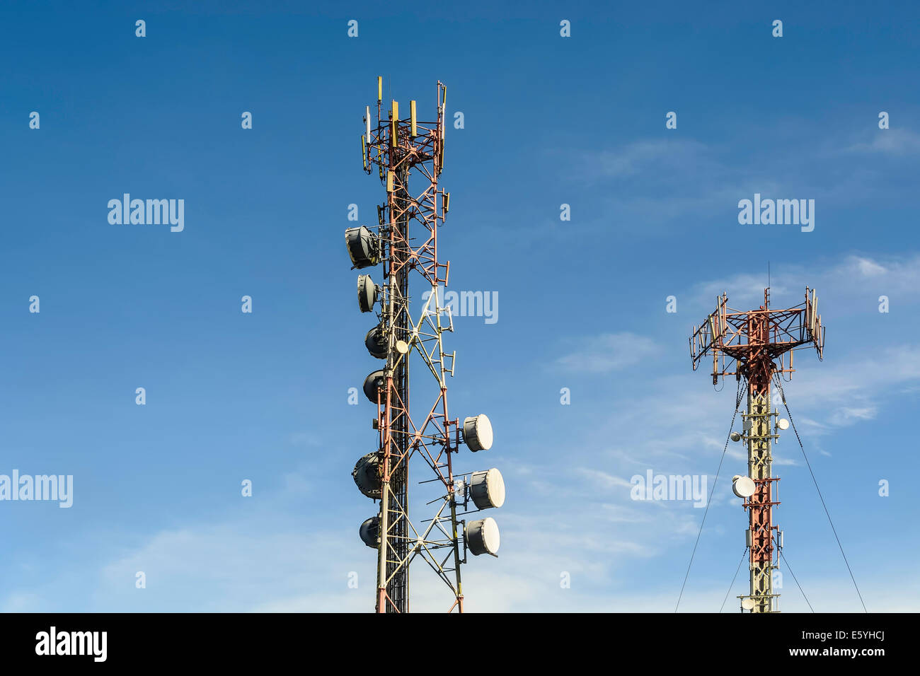 Two communication towers shot against blue sky Stock Photo - Alamy