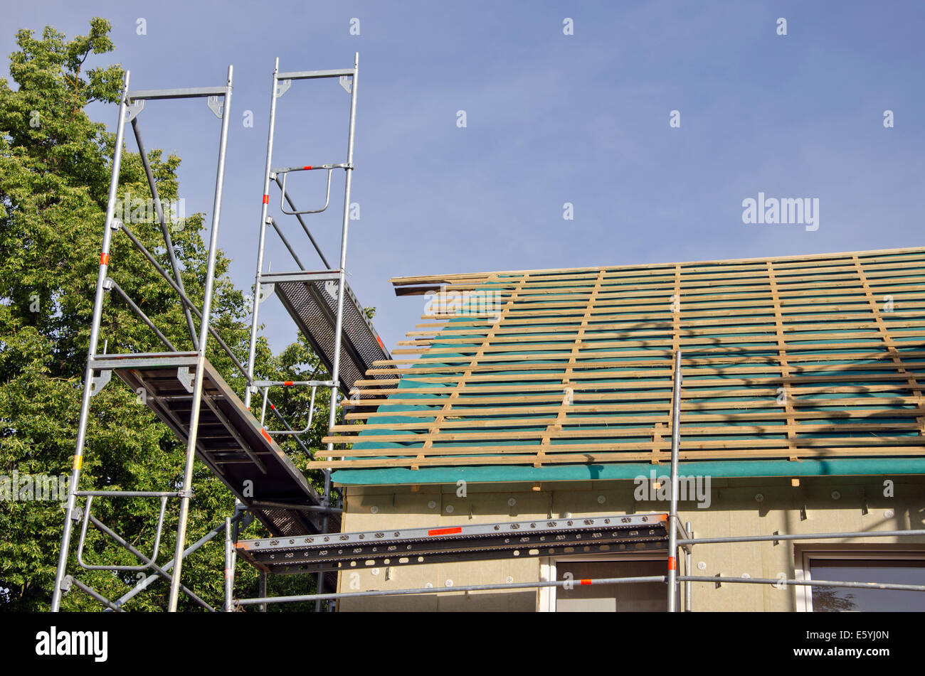 city house repair roof new construction and scaffold Stock Photo - Alamy