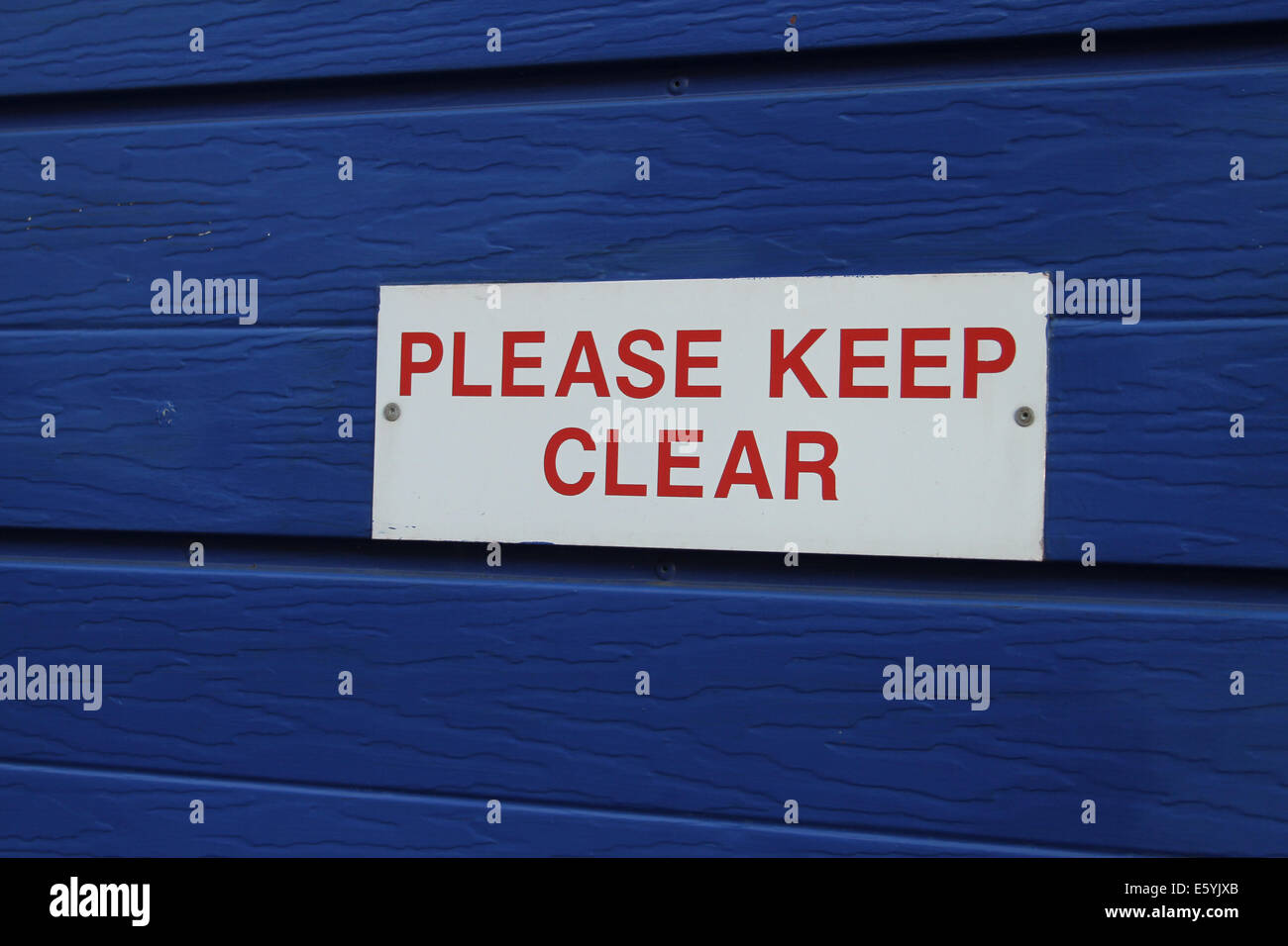 Please keep clear warning sign in red on a white background on a blue ...