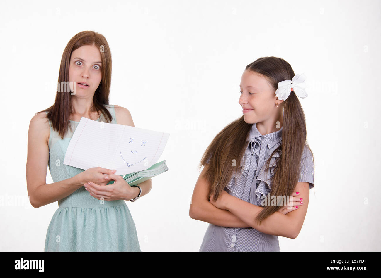 Teacher checking notebooks students saw one of them funny painted a ...