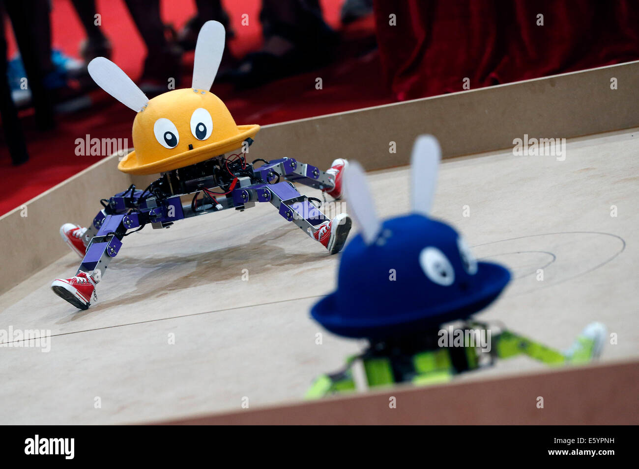 Beijing, China. 9th Aug, 2014. Two robots stage a performance during a ...