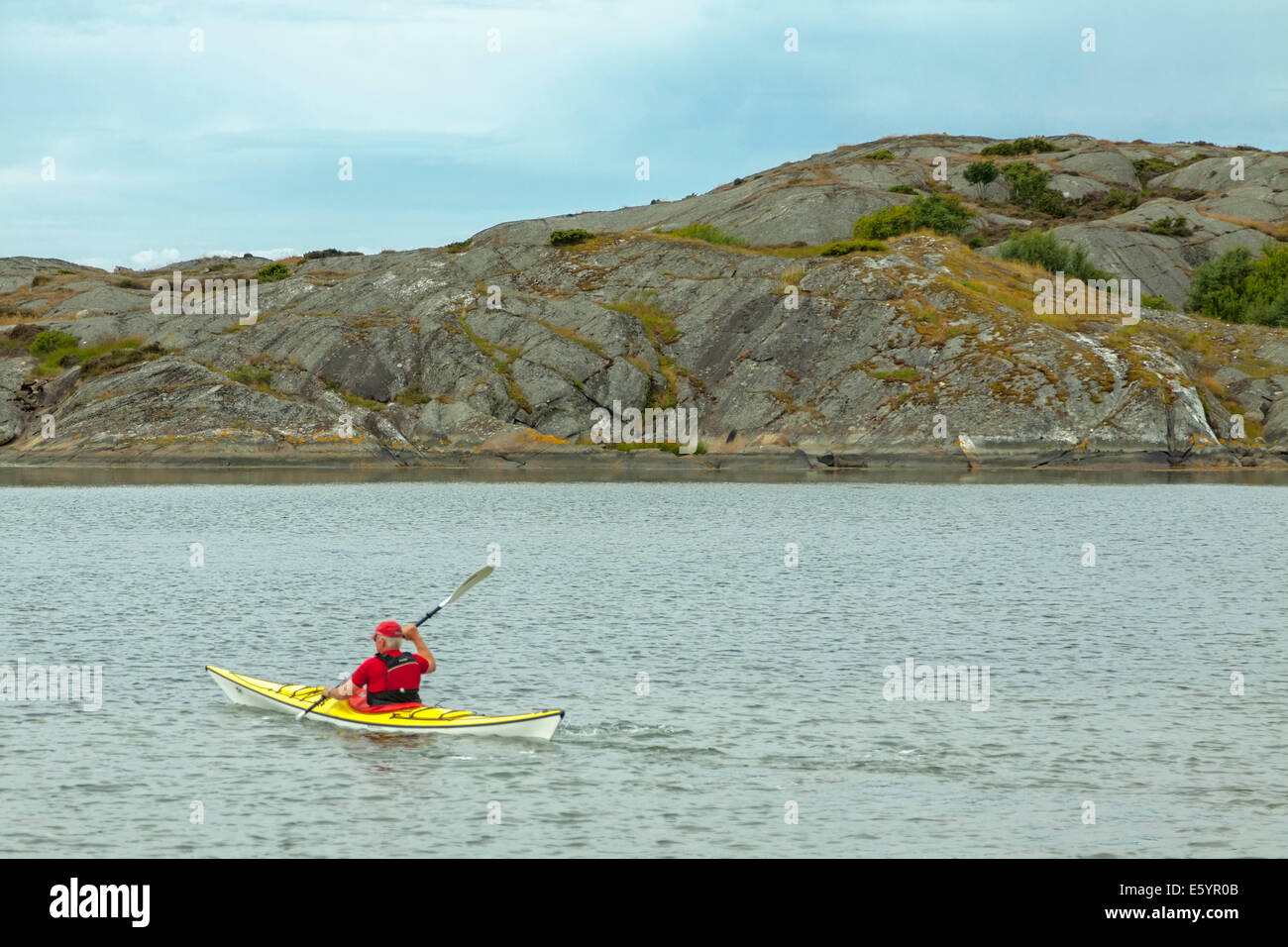 Man kayaking in the stunning landscape of the Swedish Archipelago at ...