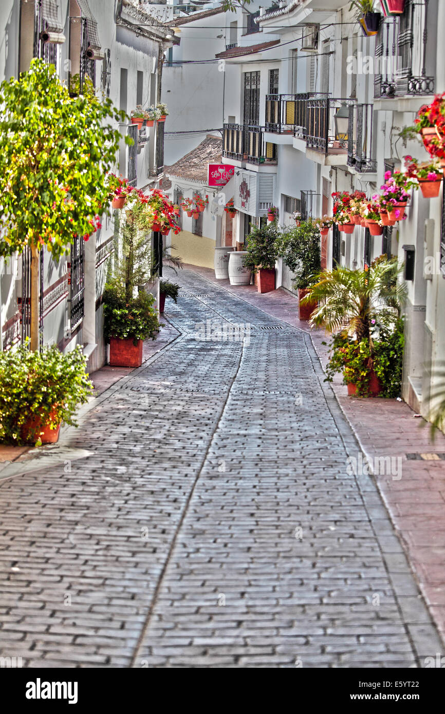 View of typical narrow Spanish street in Estepona Spain Stock Photo - Alamy