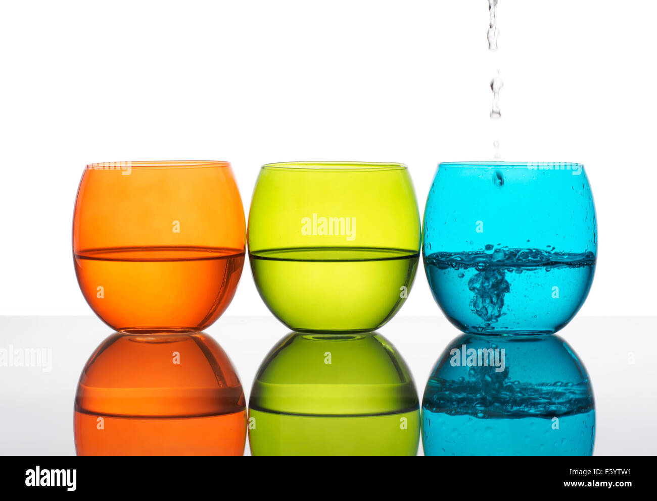 Beautiful glasses with pouring water Stock Photo - Alamy