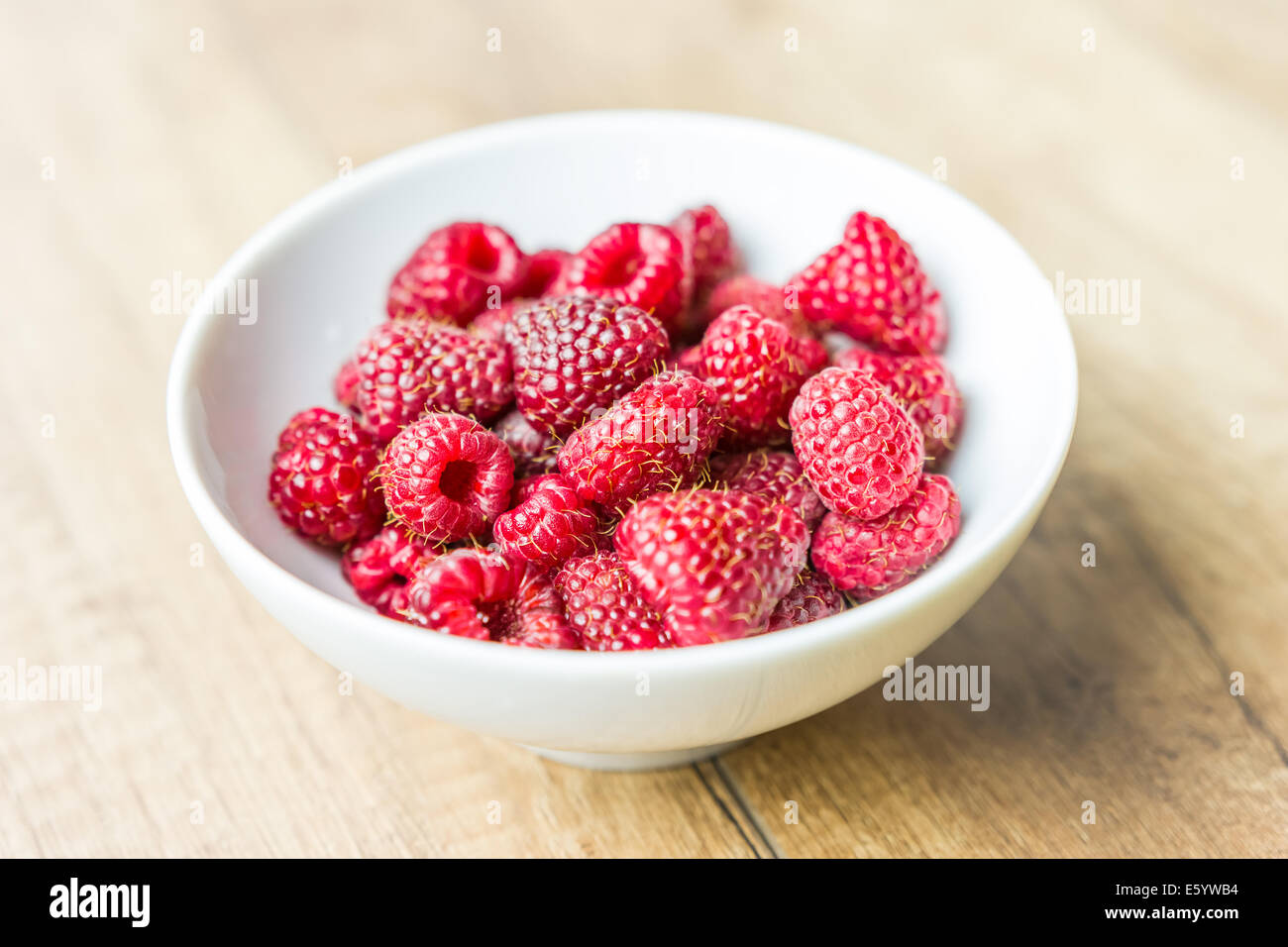 Fresh Raspberry Fruits In White Bowl Stock Photo - Alamy