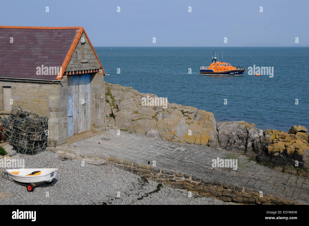 An RNLI Lifeboat behind the old Lifeboat house at Moelfre on Anglesey ...