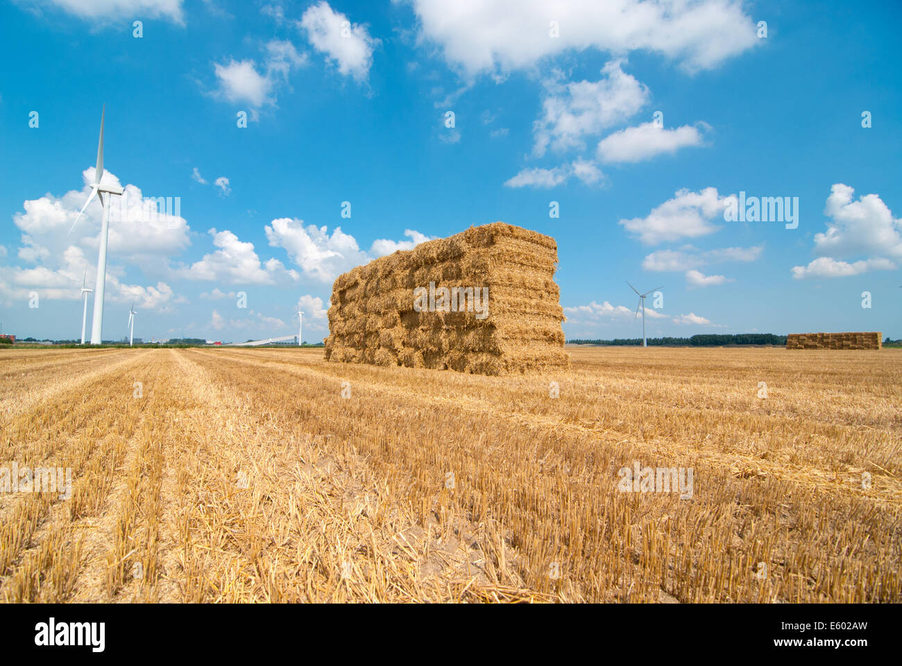 Haystack and wind turbines on farmland Stock Photo - Alamy
