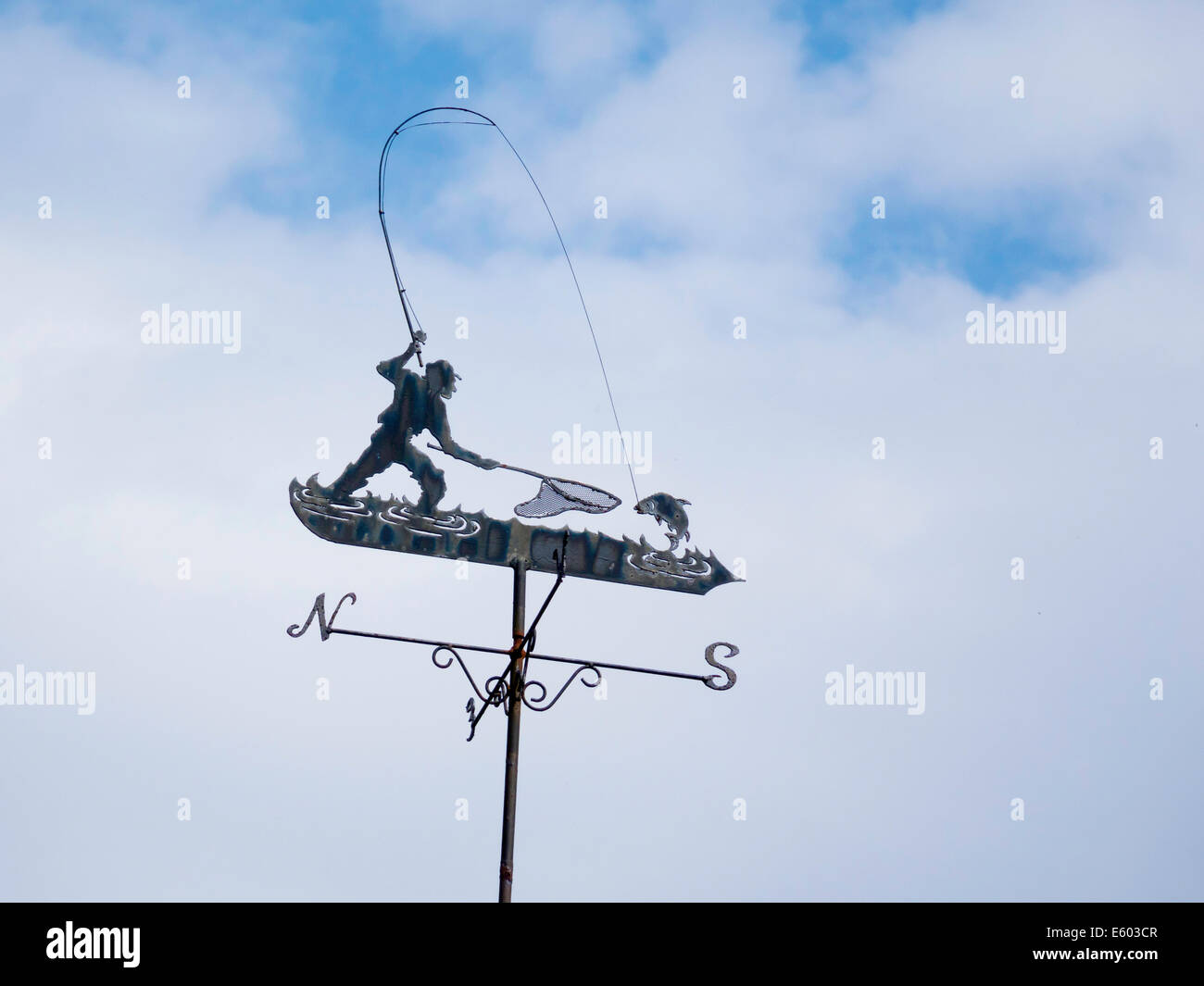 An unusual farm weather vane featuring an angler netting a large trout ...