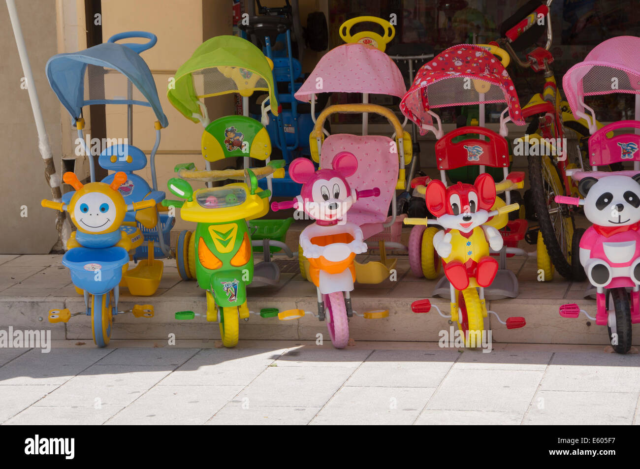 Zante, Greece - colourful Disney themed toy tricycles Stock Photo - Alamy