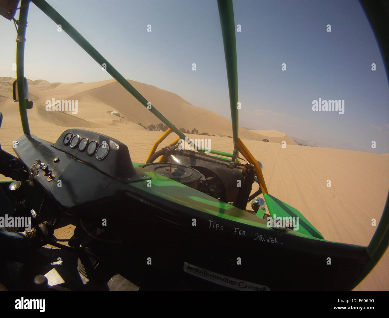 A 4 wheel drive buggy races through the sand dunes of the desert near ...