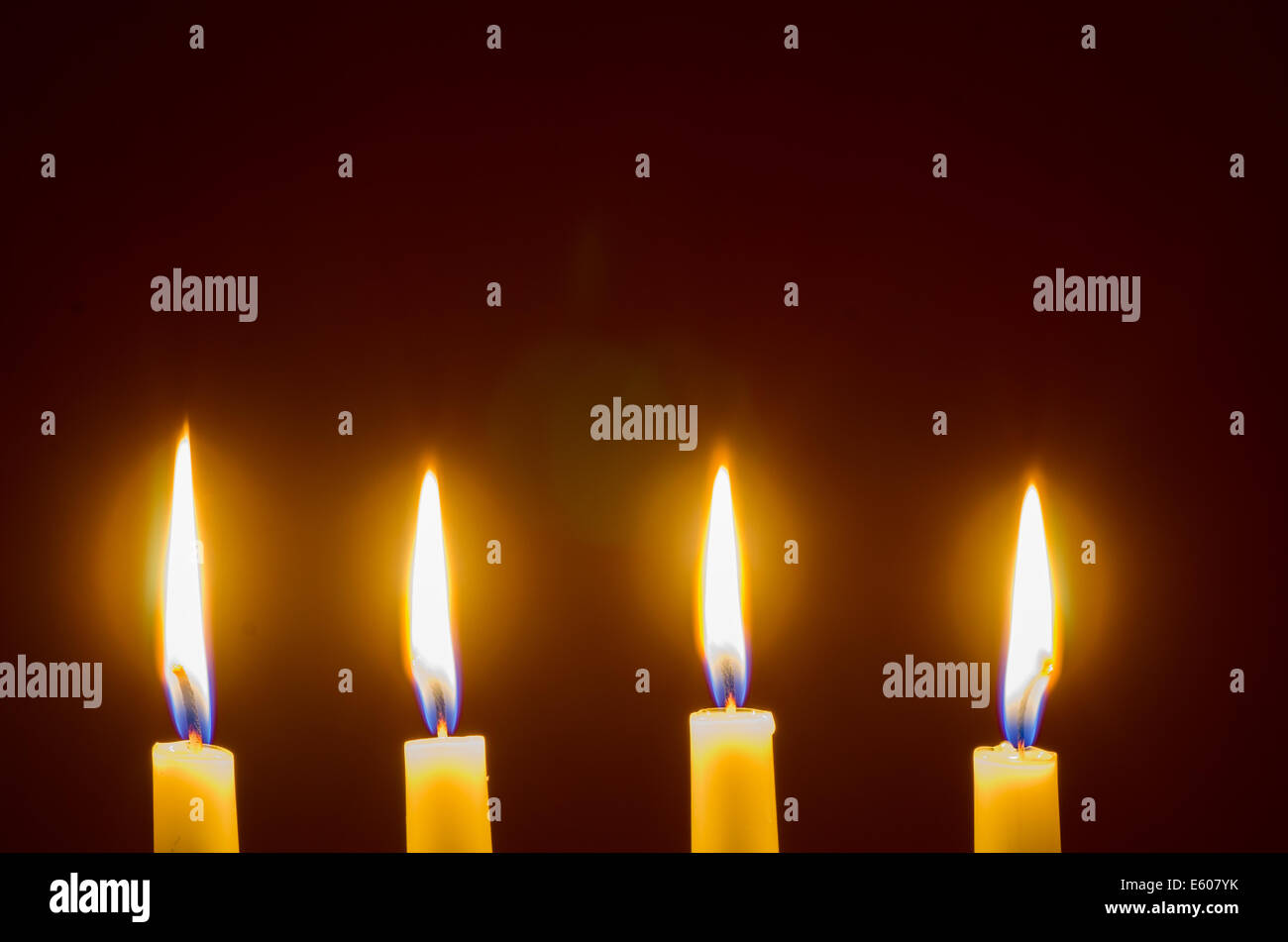 closeup to four candles in dark Stock Photo - Alamy