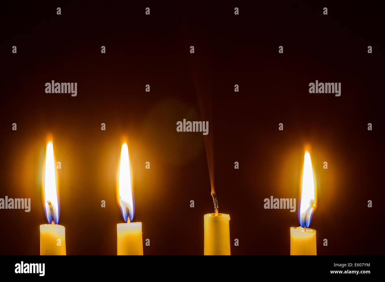 closeup to four candles in dark Stock Photo - Alamy