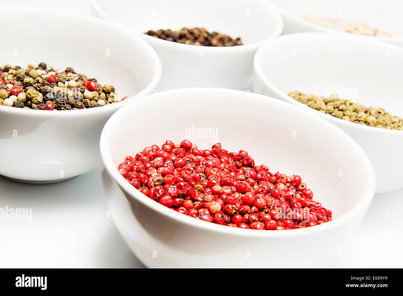 Red pepper seeds on a white bowl Stock Photo - Alamy