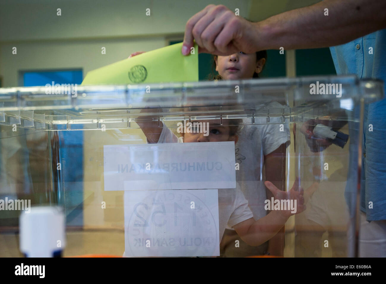 Ankara, Turkey. 10th Aug, 2014. A boy puts his father's ballot into the ...