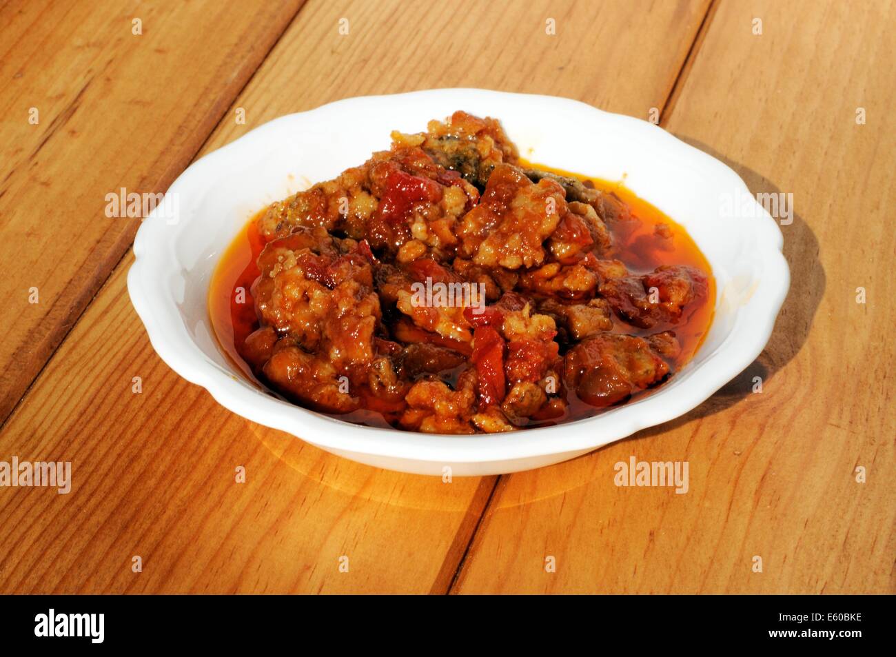 Tapas dish of pieces of cod in red pepper and tomato sauce, Andalusia ...