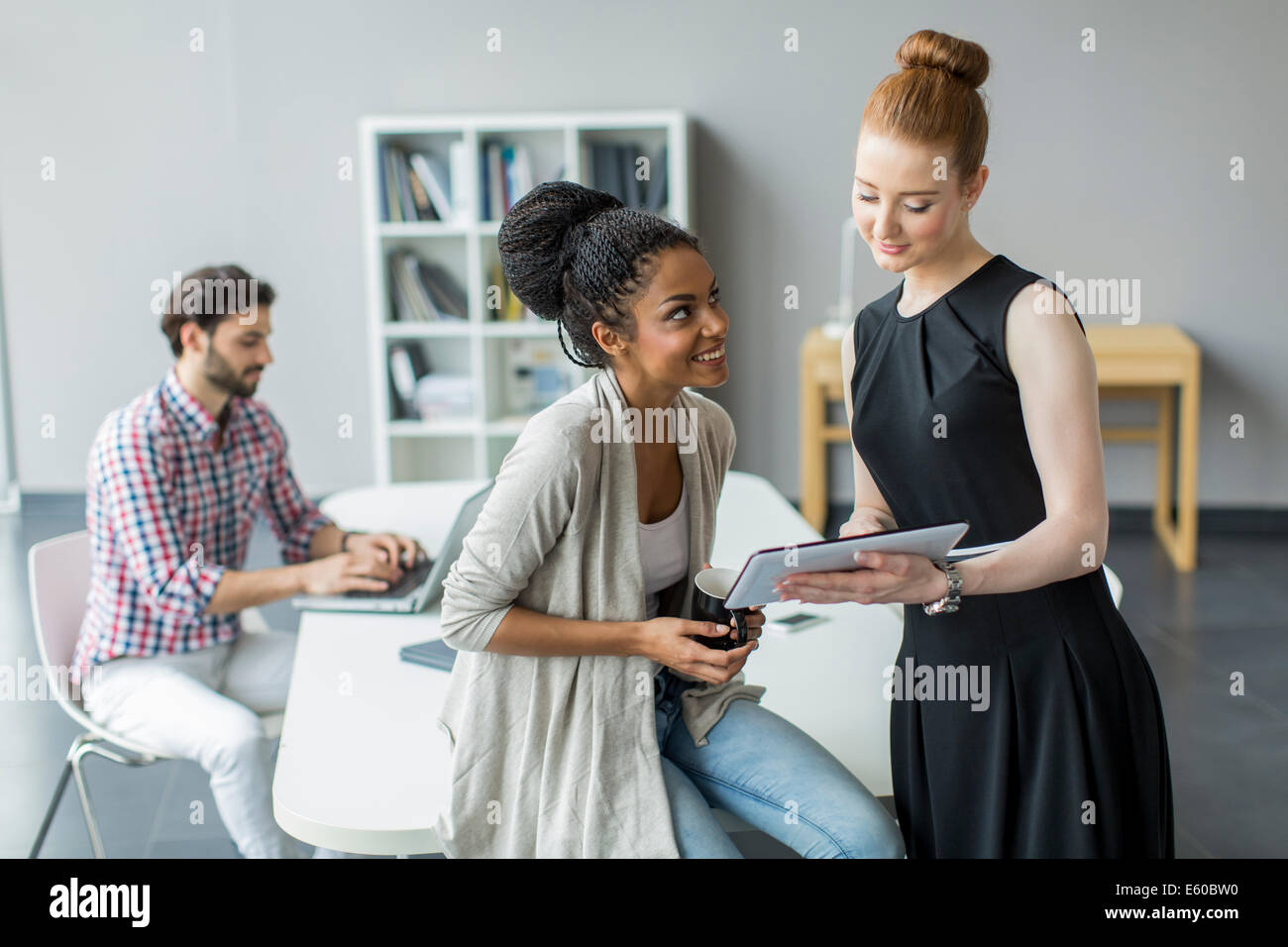 Young people in the office Stock Photo - Alamy