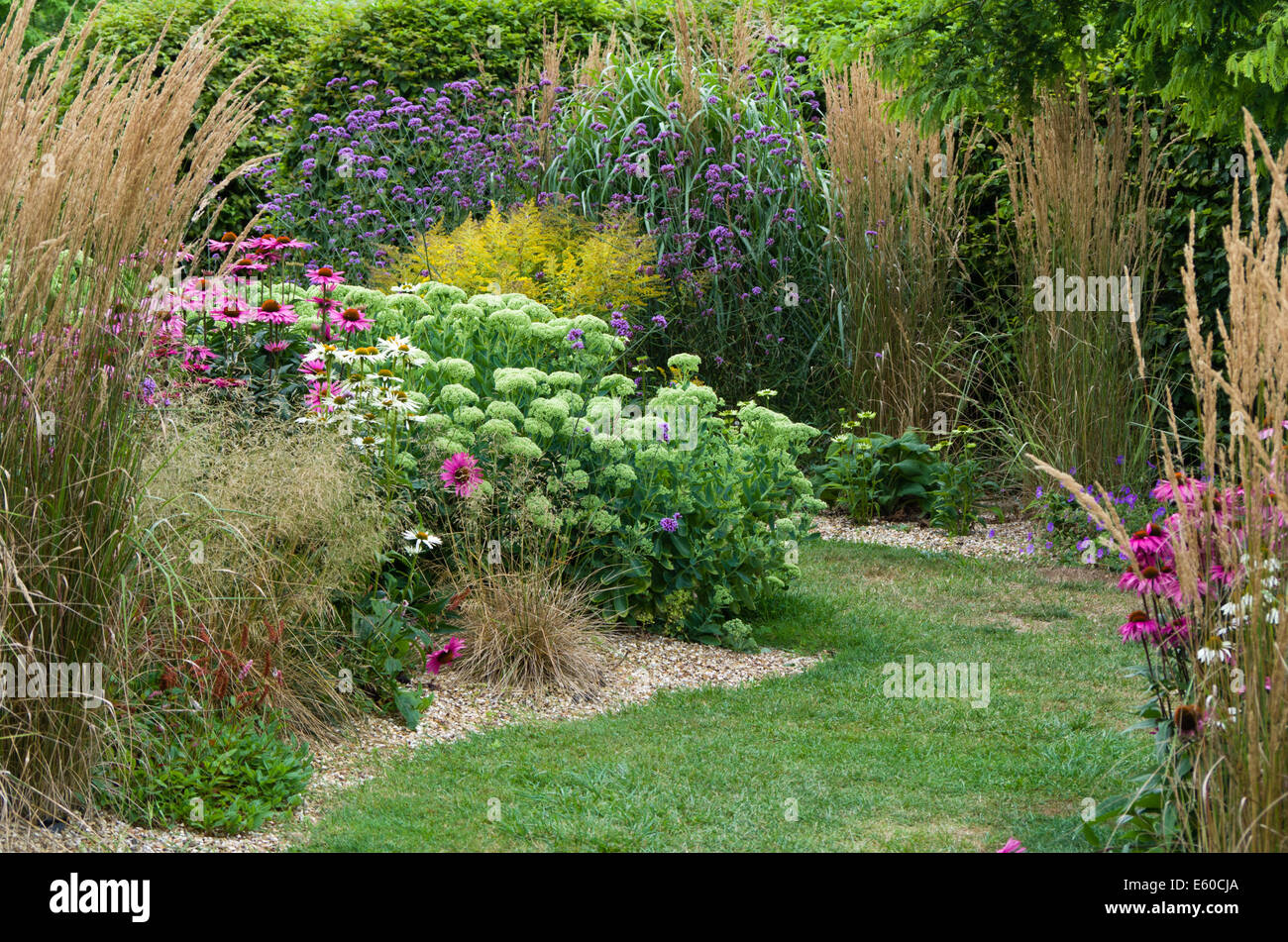 A grassy path winding its way through informal flower borders at Kathy ...