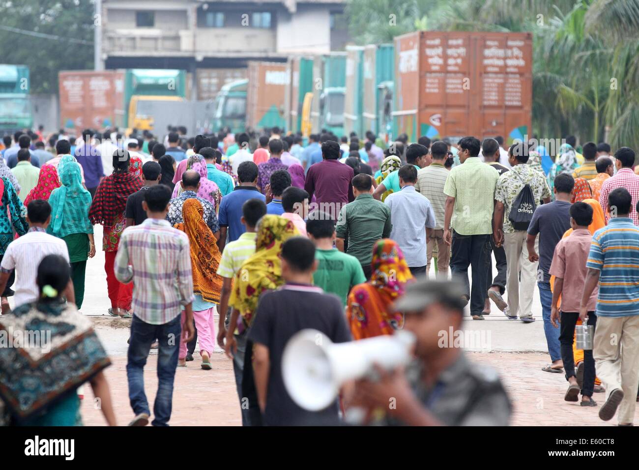 Garment workers are in a long queue to join their workplace in Ashulia ...