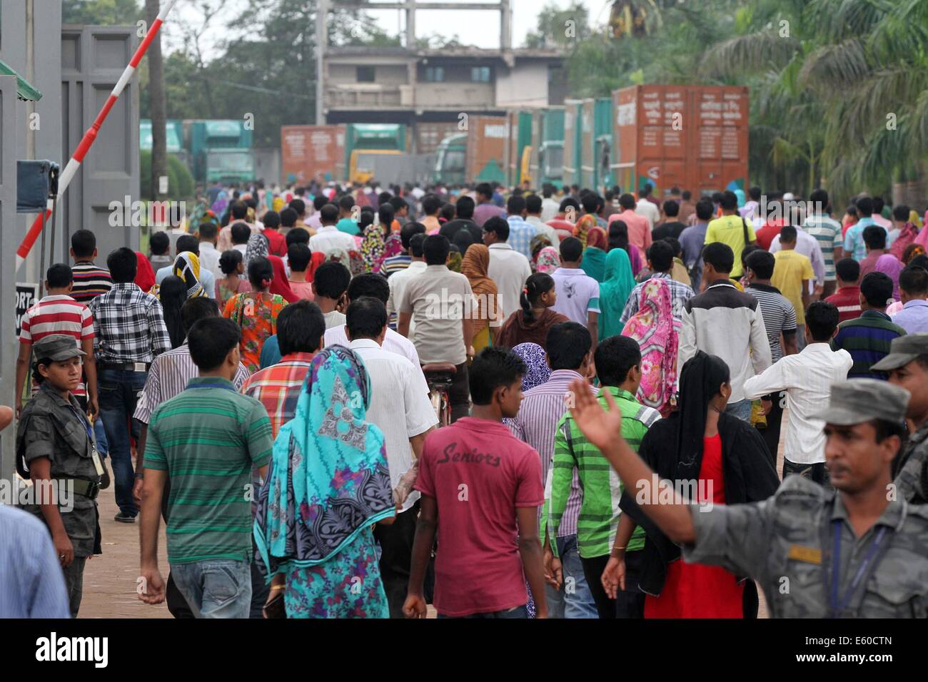 Garment workers are in a long queue to join their workplace in Ashulia ...