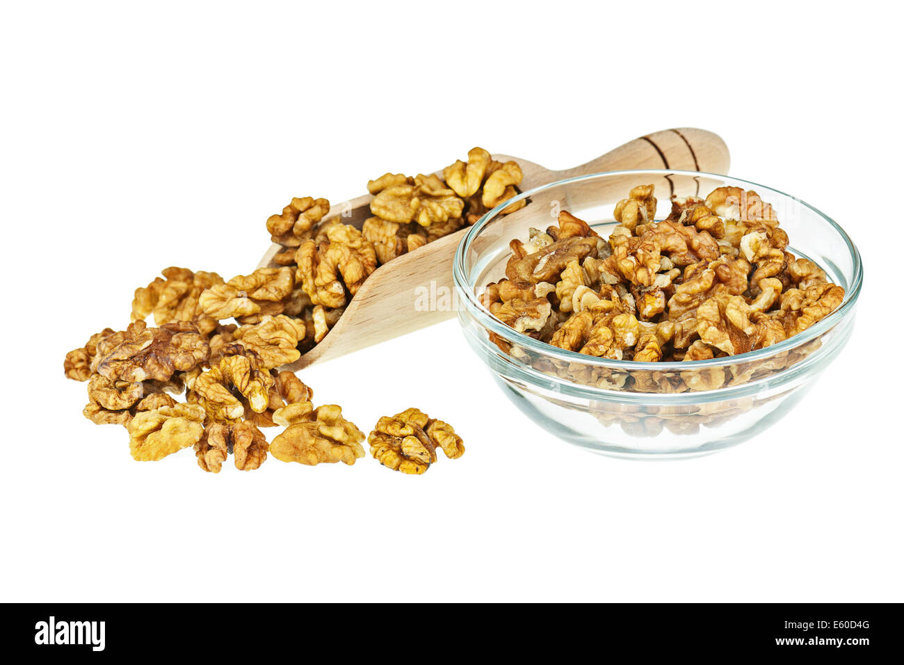 Handful of walnuts in scoop and glass bowl isolated on white background ...