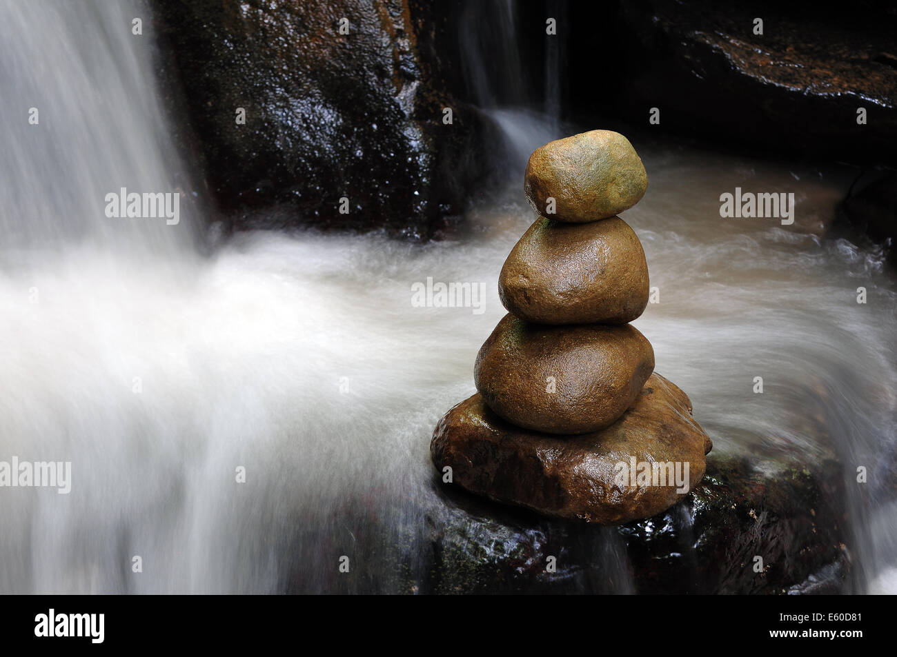 Stacked zen stones and waterfall Stock Photo - Alamy