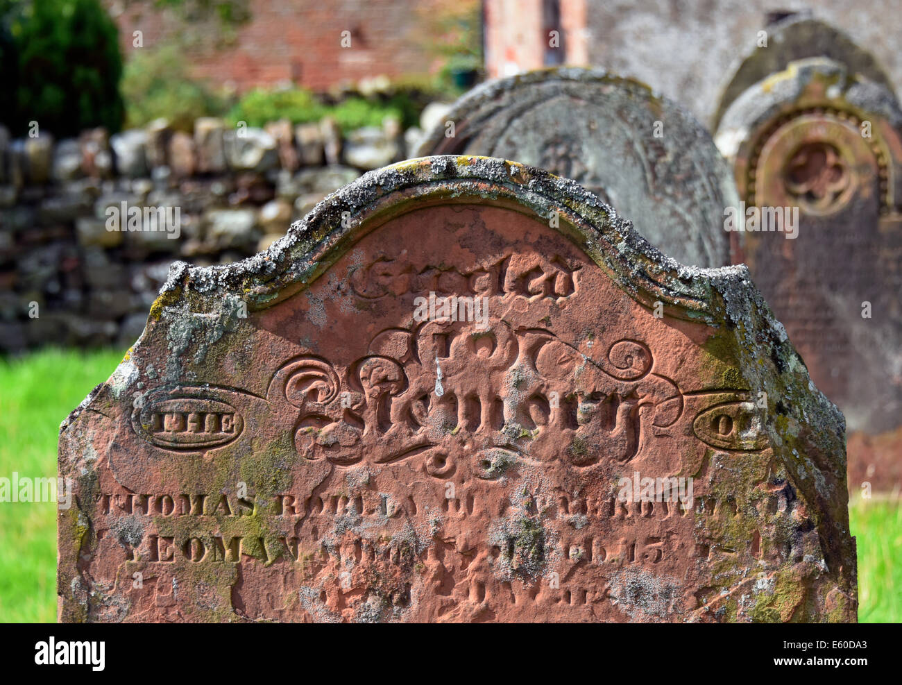 Badly eroded sandstone gravestone. Church of Saint John the Baptist ...