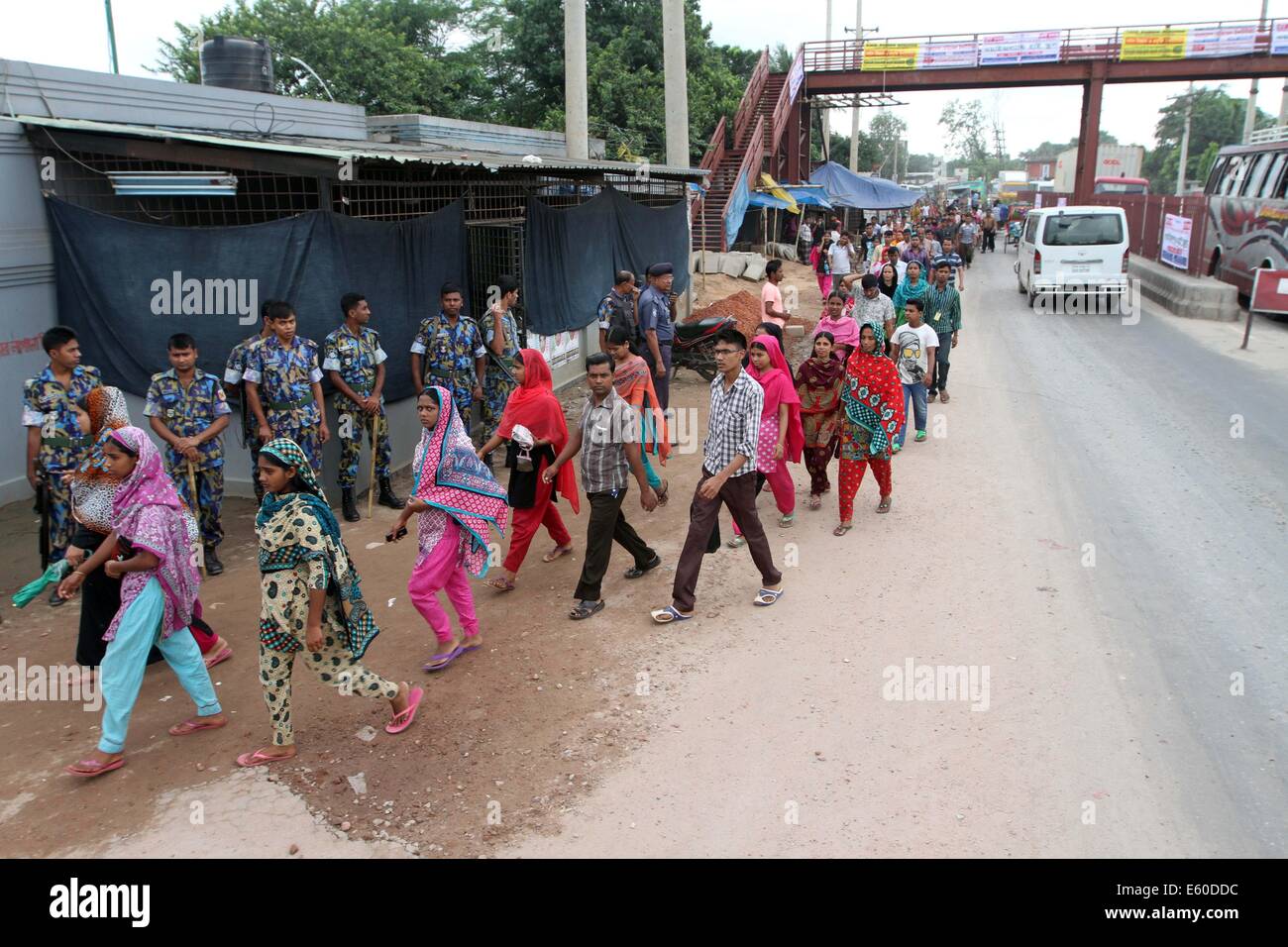 Garment workers are in a long queue to join their workplace in Ashulia ...