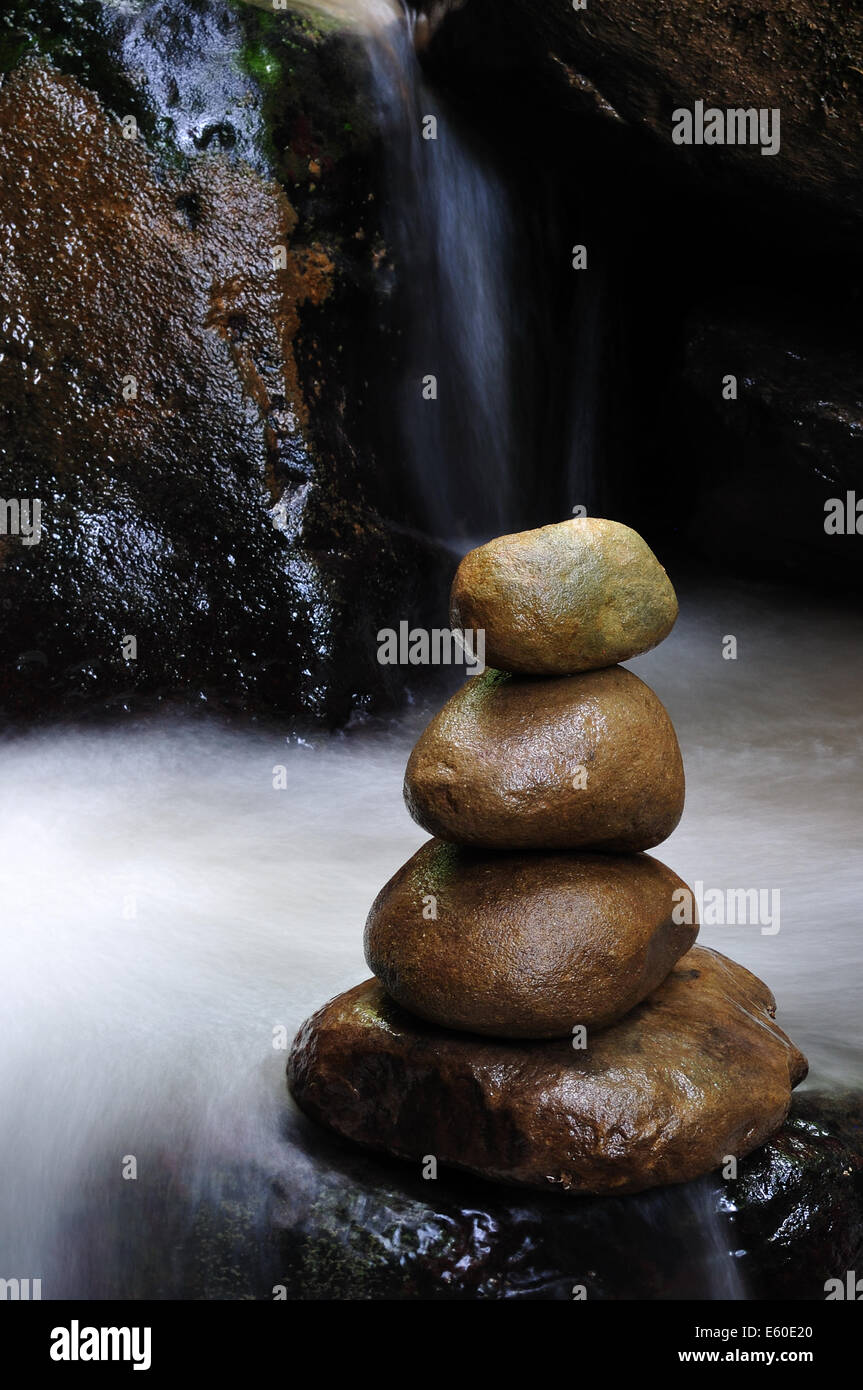 Stacked zen stones and waterfall Stock Photo - Alamy