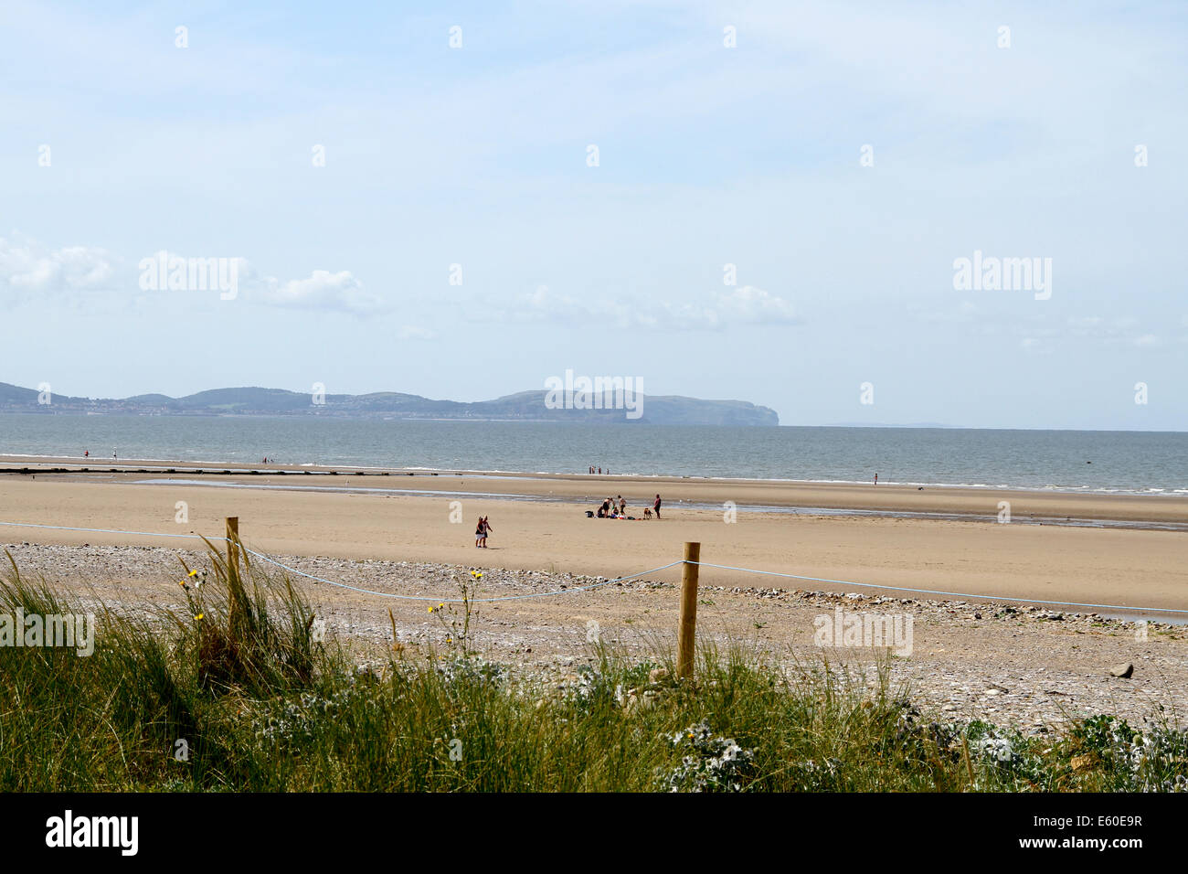 People play and strolling on the beach at Towyn near Rhyl North Wales ...