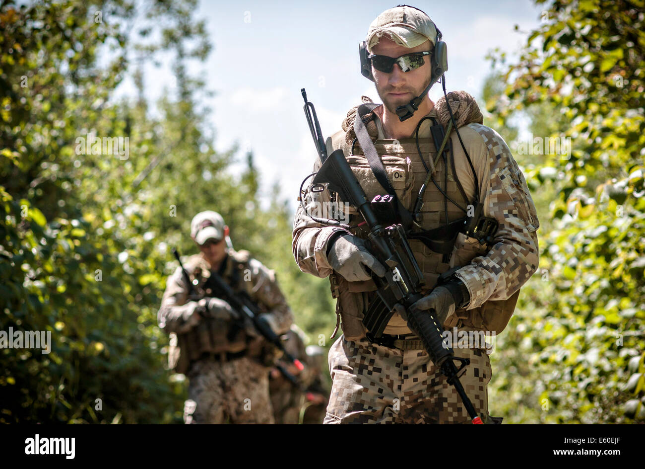 Latvian Armed Forces soldiers patrol during a close air support mission ...